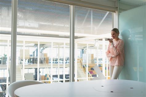 Premium Photo Businesswoman Talking On Mobile Phone In The Conference Room At Office