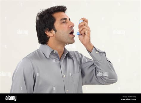 Man Using Asthma Inhaler Stock Photo Alamy