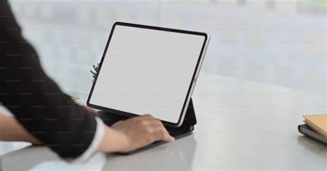 사무실의 흰색 책상에서 디지털 태블릿 모형으로 작업하는 사업가 손의 클로즈업 보기 클리핑 경로 사진 Unsplash의 일하는 장소 이미지