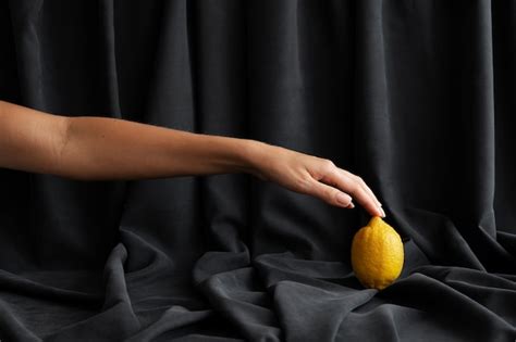 Free Photo Side View Arm Posing With Lemon