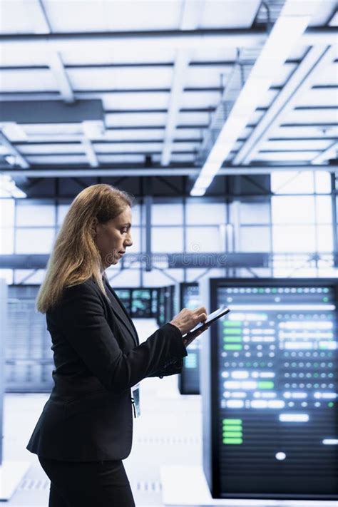 Software Developer Using Tablet In Data Center With Advanced Tech Stock