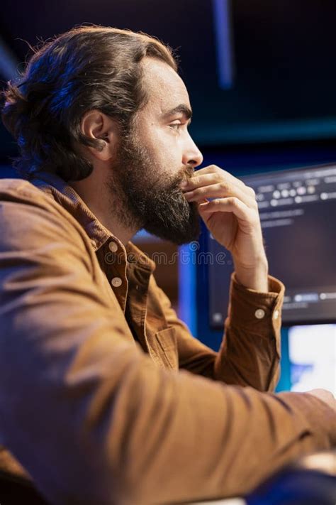 Programmer Carefully Reading Lines Of Code On Desktop Pc Monitor Stock