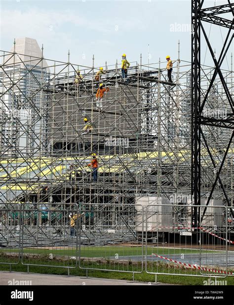 Workers Putting Up A Temporary Scaffolding Seating Structure For An