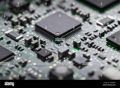 A Close Up Of A Printed Circuit Board With A Processor And Various Elements In Backlight Stock