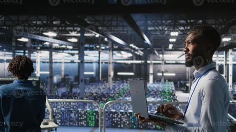 Technicians On Data Center Industrial Platform Analyzing Performance