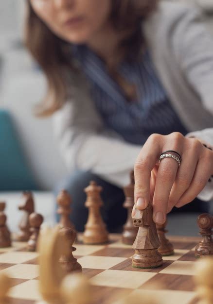 Premium Photo Woman Playing Chess And Moving A Piece