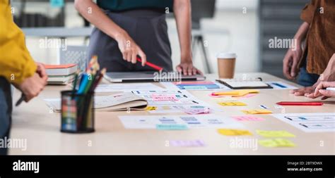 Close Up Ux Developer And Ui Designer Brainstorming About Mobile App