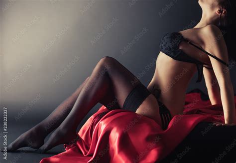 Sexy Young Brunette Woman In Black Sensual Lingerie And In Stockings