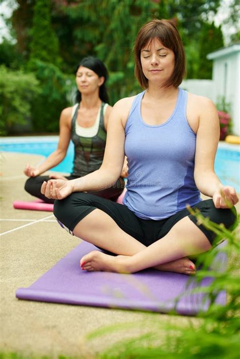 Two Mature Women Keeping Fit By Doing Yoga In The Summer Stock Image