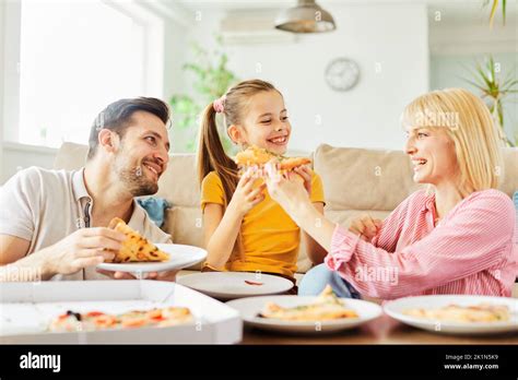 pizza family child food home eating daughter mother father happy meal together lunch dinner man ...