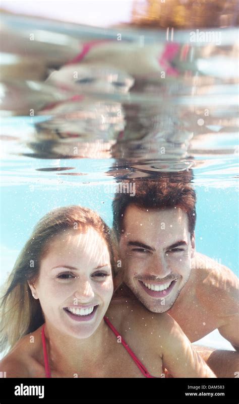 Couple Smiling In Swimming Pool Stock Photo Alamy