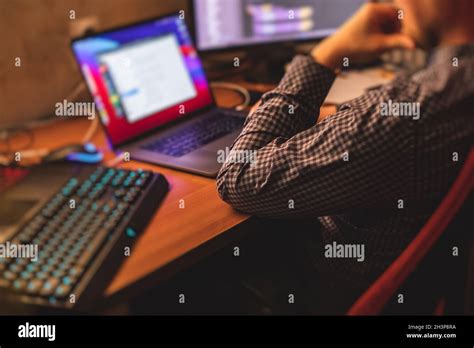 It Developer Programmer Working And Coding On His Worplace At Home Laptop And Desktop Monitor