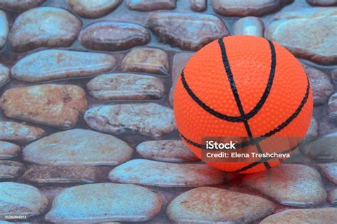 Basketball Ball On Pebbles Cobblestone Road Surface Close Up Background