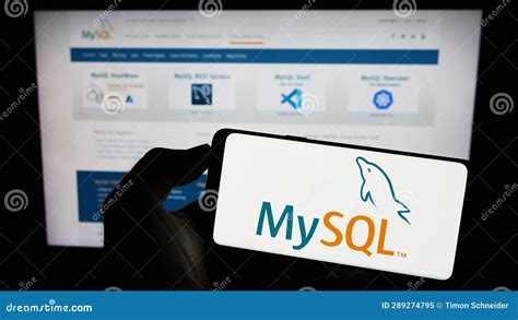 Person Holding Cellphone With Logo Of Relational Database Management System Mysql On Screen In