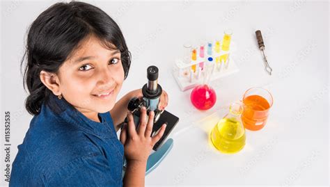 Photo Stock Curious Indian Girl With Microscope Asian Girl With