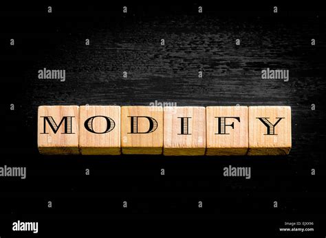 Word Modify Wooden Small Cubes With Letters Isolated On Black