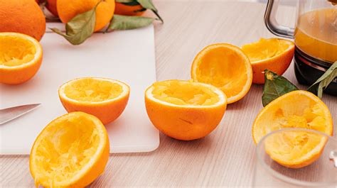 신선한 오렌지 주스를 붓습니다 나무 판에 압착 오렌지 부품 신선한 오렌지 주스 한 잔을 닫습니다 건강하고 채식주의 자 식단 주방 테이블에 과일 음료 0명에 대한 스톡 사진