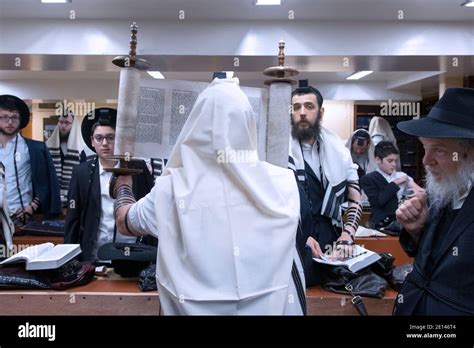 After A Torah Reading At A Synagogue A Man Shows The Letters Of The Scroll To The Congregation