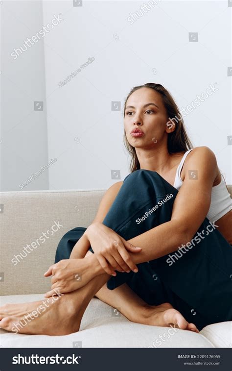 Woman Sits Relaxed On Couch Smiles Stock Photo Shutterstock