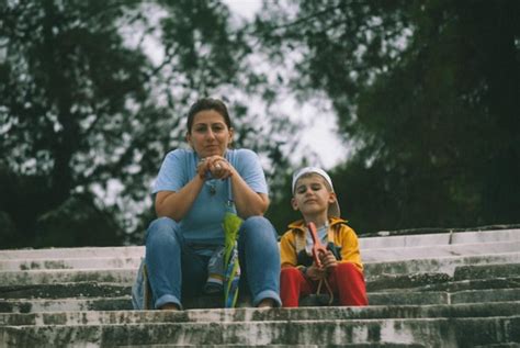 Premium Photo Low Angle View Of Mother And Son Sitting On Steps