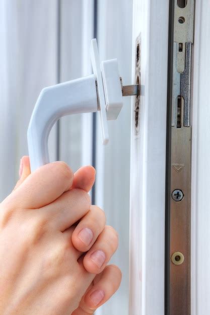 Premium Photo Hands Locksmith Remove Handle Of Window Frame Close Up