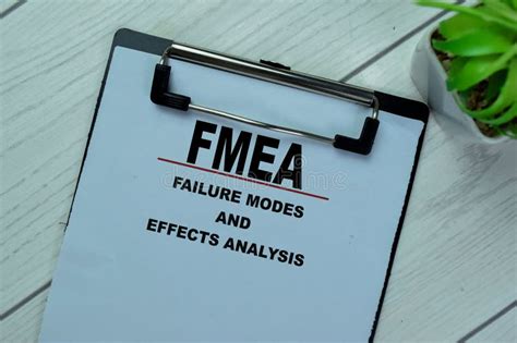 Concept Of FMEA Failure Modes And Effects Analysis Write On Paperwork Isolated On Wooden Table