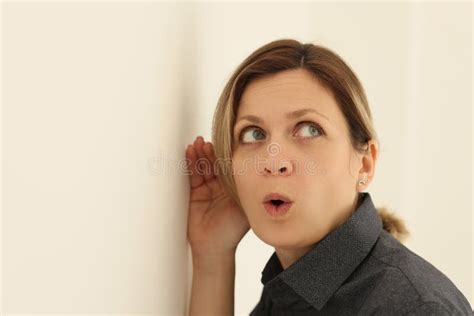 Curious Woman Listens To Discussion Of Colleagues In Office Stock Image