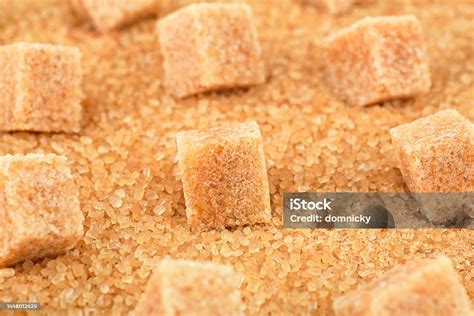 Brown Sugar Cubes On Cane Sugar Crystals Close Up Demerara Golden Sugar