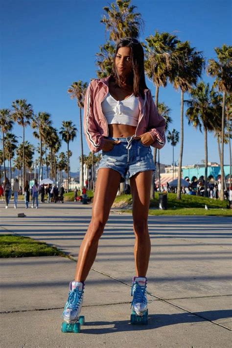 A Woman Standing On The Sidewalk With Her Legs Crossed