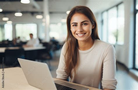 Joyful Female Web Developer At Work In A Bright Daytime Office