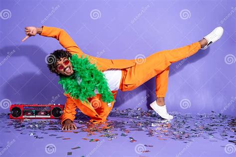 Full Length Photo Of Attractive Funny Guy Wear Orange Suit Dancing Pointing Boom Box Emtpy Space