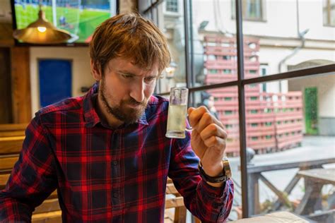 한 남자가 술집에 있는 테이블에 혼자 앉아 강한 술을 마십니다 알코올 중독 알코올 중독 30 39세에 대한 스톡 사진 및 기타 이미지 30 39세 개념 건강관리와