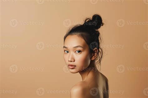 Ai Generated Portrait Of A Young Asian Woman With Tied Hair On Her Head And Bare Shoulders On A