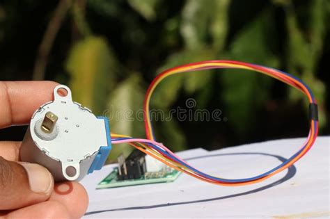 Stepper Motor Held In The Hand That Is Used In Many Prototyping Projects Connected To A Motor