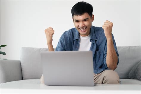 Happy Excited Asian Man Looking At Laptop Man Receiving Good News