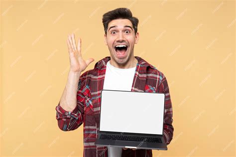 Premium Photo Shocked Man Gesticulating And Shouting Demonstrating Laptop With A Blank Screen
