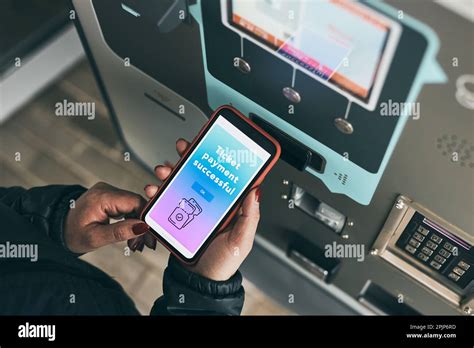 Woman Buying Ticket At Ticket Machine Paying Using Mobile Payment App