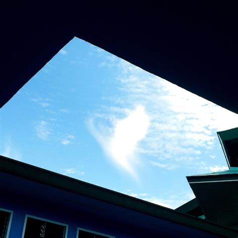 Low Angle View Of Sky Seen Through Window Premium Photo