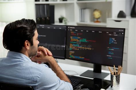 Concentrating In Smart It Developer Working Coding On Two Pc Screen