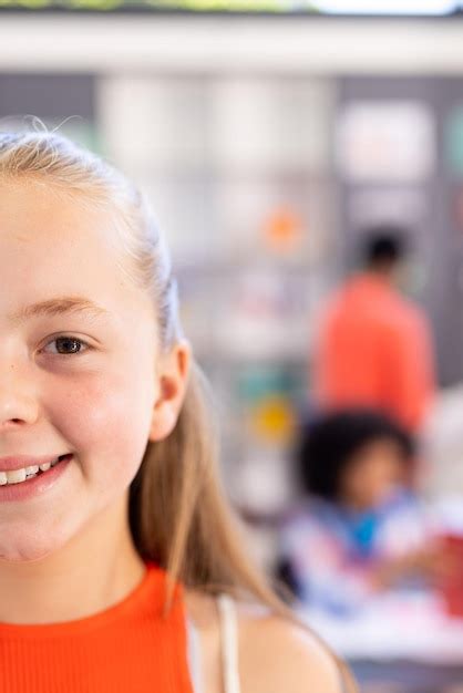 Premium Photo Half Face Portrait Of Smiling Caucasian Schoolgirl In Classroom Copy Space
