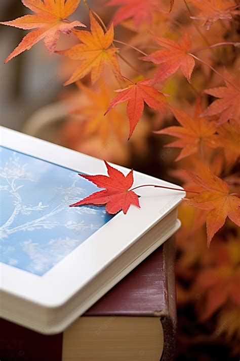 Book On Top Of Tablet With Autumn Leaves Background Wallpaper Image For