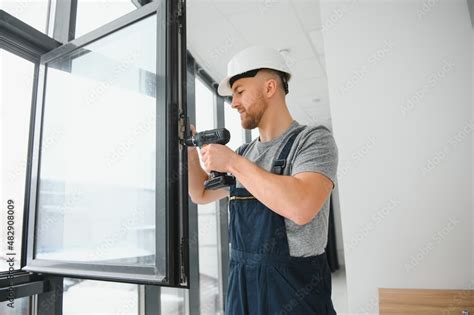 Handsome Babe Man Installing Bay Window In New House Construction Site Stock Photo Adobe Stock