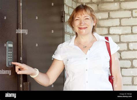 Mature Woman Pushing Button Of House Intercom Outdoor Stock Photo Alamy