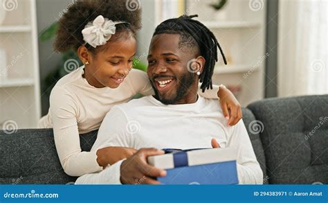 African American Father And Daughter Surprise With T Sitting On Sofa