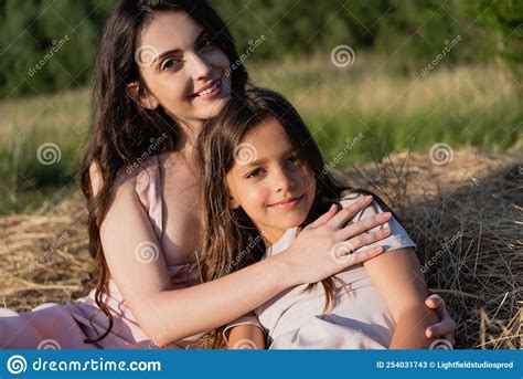 Brunette Woman Embracing Girl And Looking Stock Image Image Of