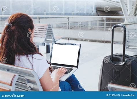 Woman Passenger Using Laptop Computer In The Airport Banking Online Or