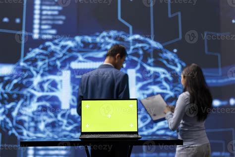 Focus On Green Screen Laptop Used By Teamworking Ai Technicians In Blurry Background Using For