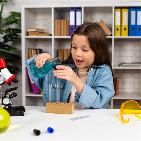 Premium Photo Cheerful Girl With Test Tubes Doing Science Experiments