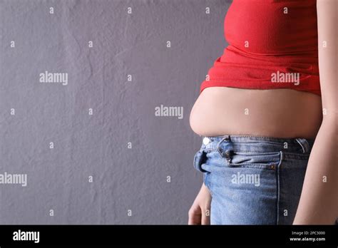 Woman Wearing Tight Clothes On Grey Background Closeup View With Space For Text Overweight