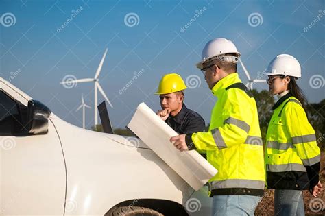 Engineers Brainstorm On A Plan To Inspect The Performance Of Wind Turbines In The Field Stock